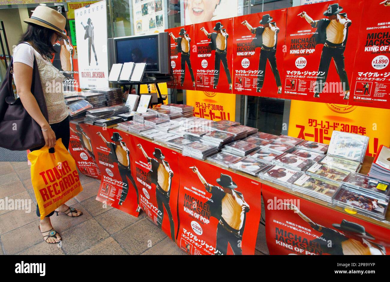 A shopper watches CDs devoted to Michael Jackson for sale at the Tower ...