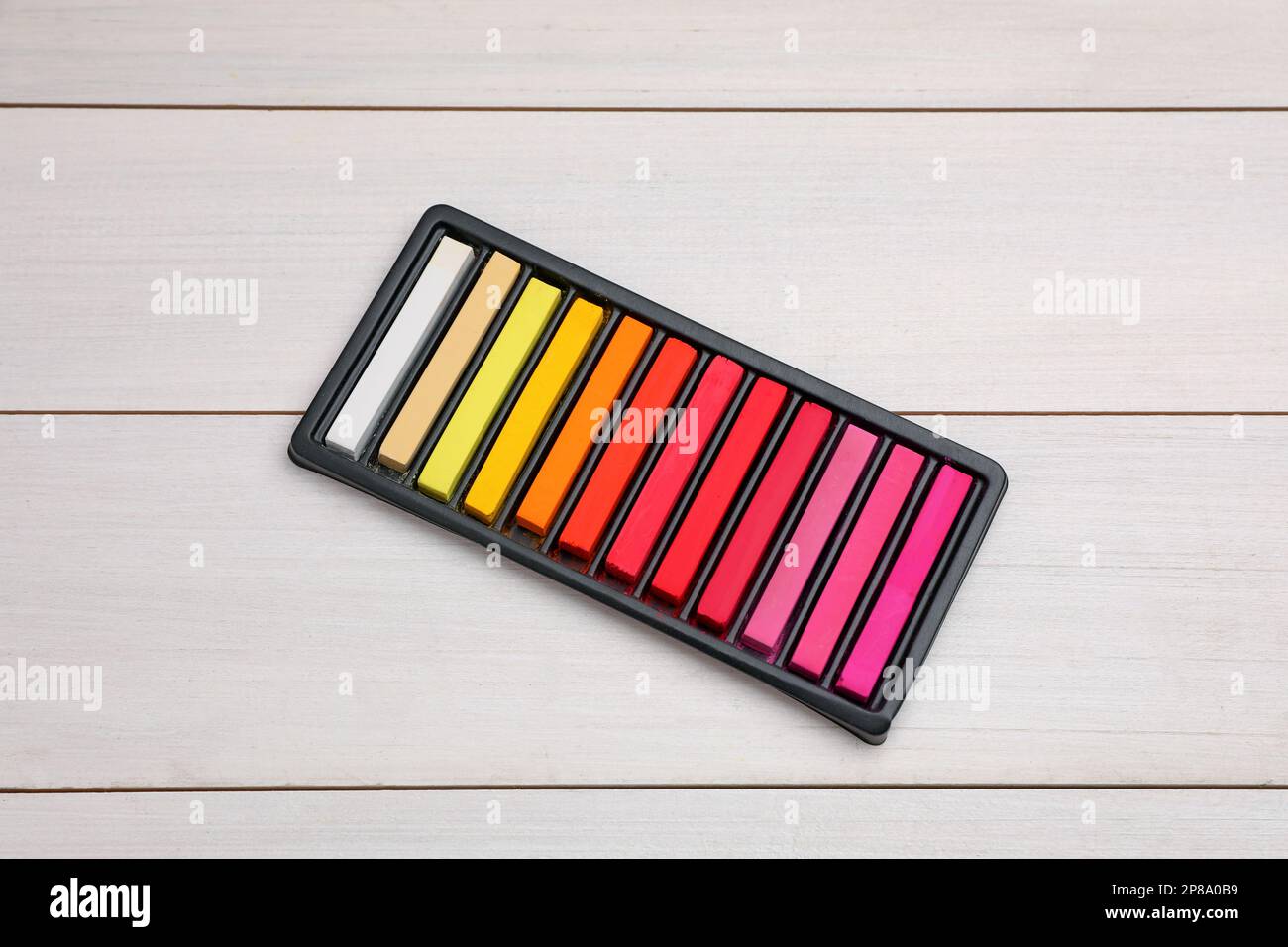 Colorful pastels in tray on white wooden table, top view Drawing ...