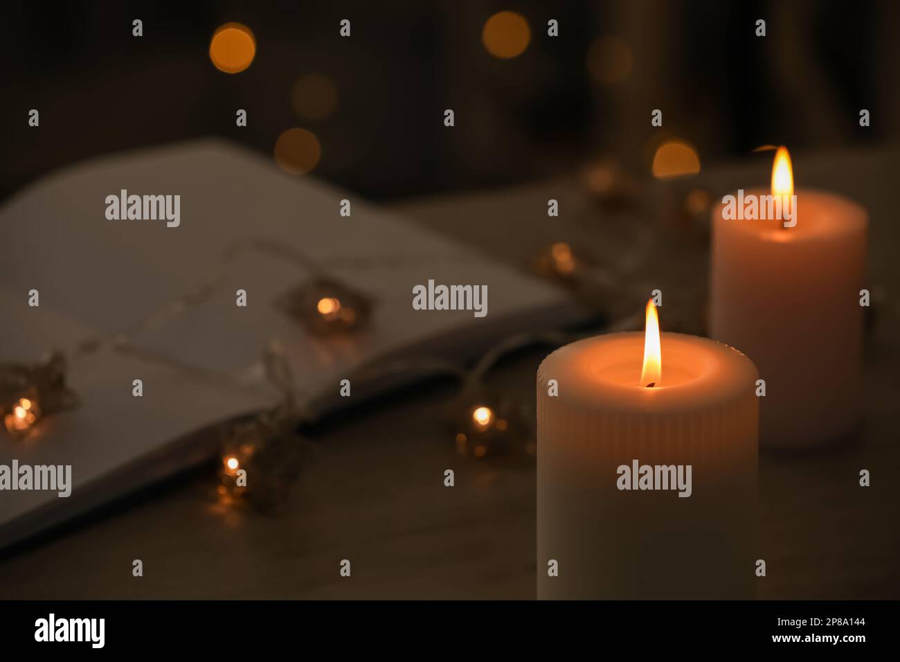 Open book burning candles hi-res stock photography and images - Alamy
