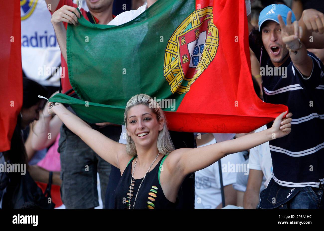 Fans of Real Madrid's new soccer player Cristiano Ronaldo wave a ...