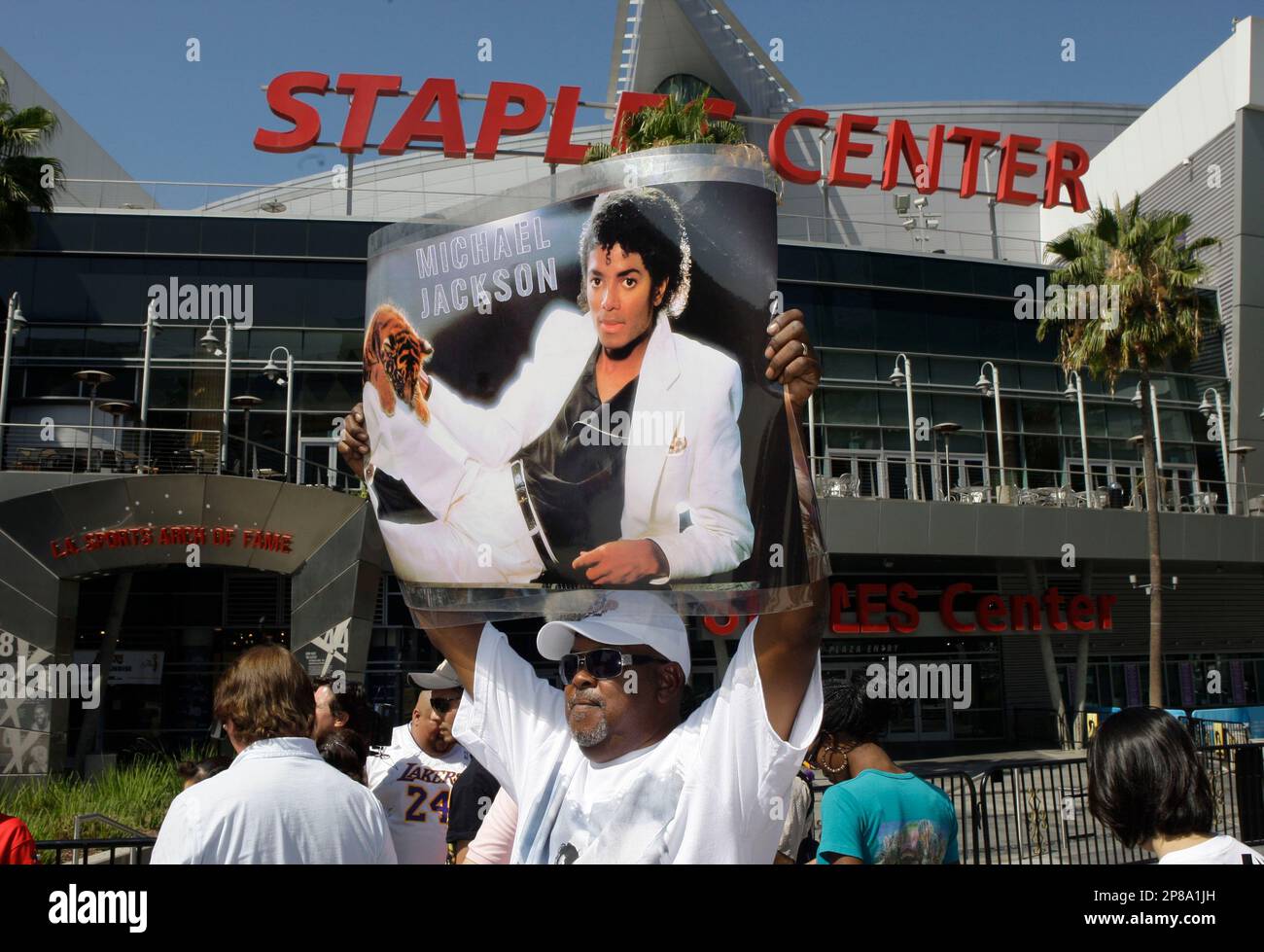 Eric Huggins, of Bakerfield, Calif., holds a Michael Jackson poster ...