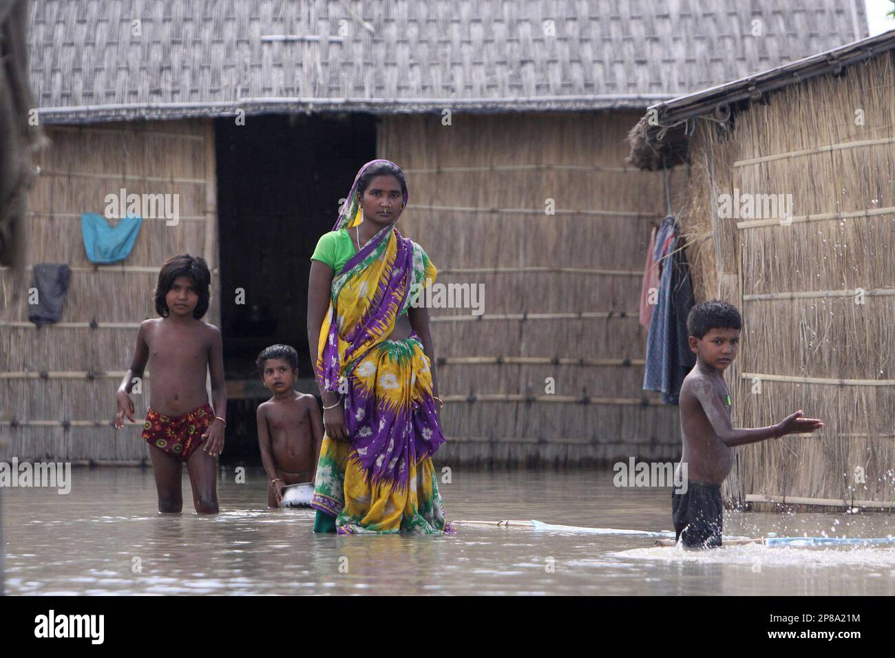 A flood affected family is seen at Kakadhowa village in lower Assam ...
