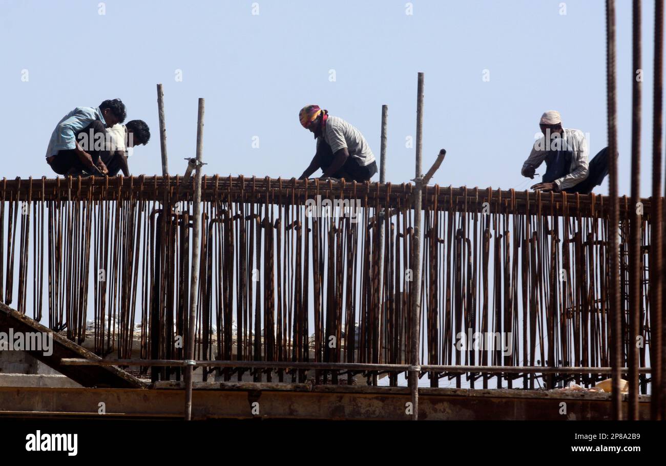 Workers work in the construction of a new bridge in the Jammu-Pathankot ...