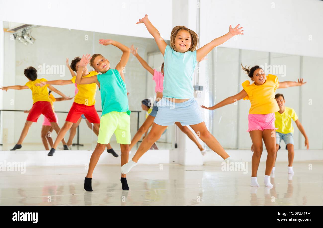 Happy sporty kids jumping in modern dance studio Stock Photo - Alamy