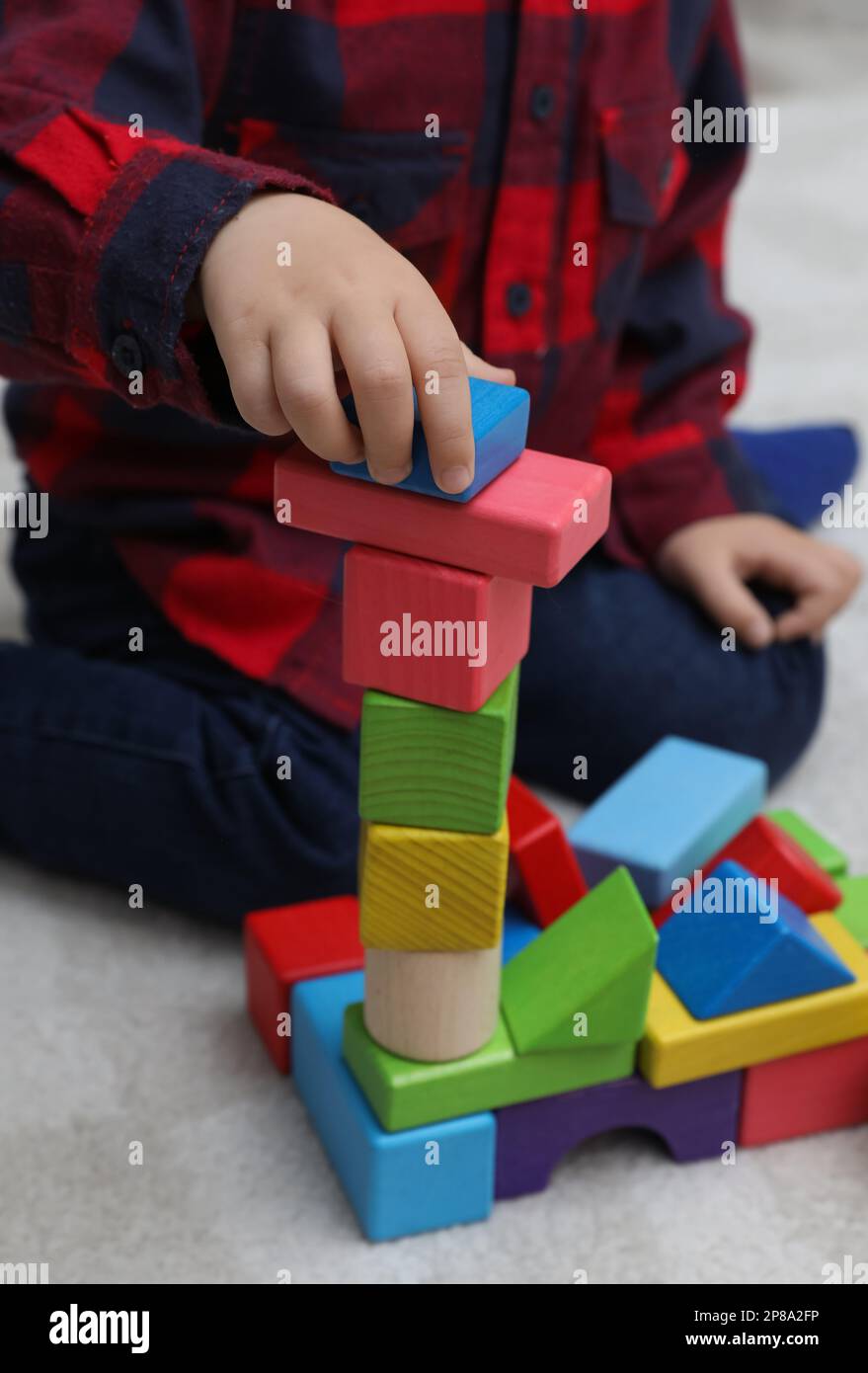 Little child playing with building blocks on carpet, closeup Stock ...