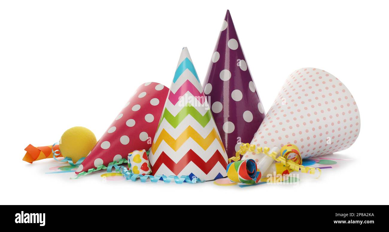 Colorful party hats, blowers and confetti streamers on white background ...