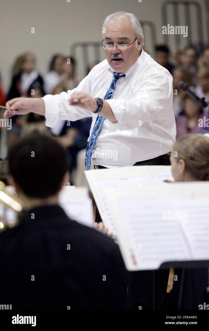 Jackson Academy band director Bruce Carter leads the musicians through ...