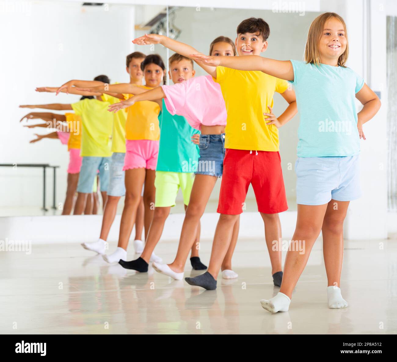 Cheerful tweens lined up one after another practicing folk dance Stock ...