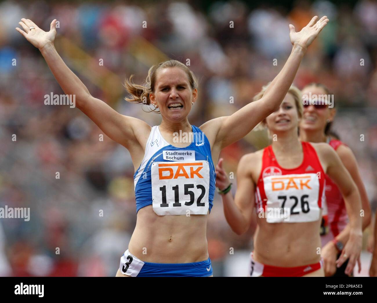 German Janina Goldfuss, left, reacts as she wins the women's 800 m ...