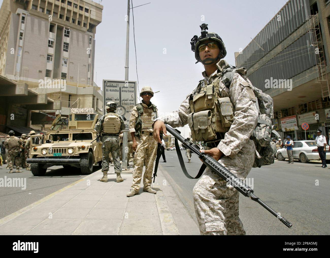 In this photo taken Tuesday, June 30, 2009, Iraqi Army soldiers stand ...