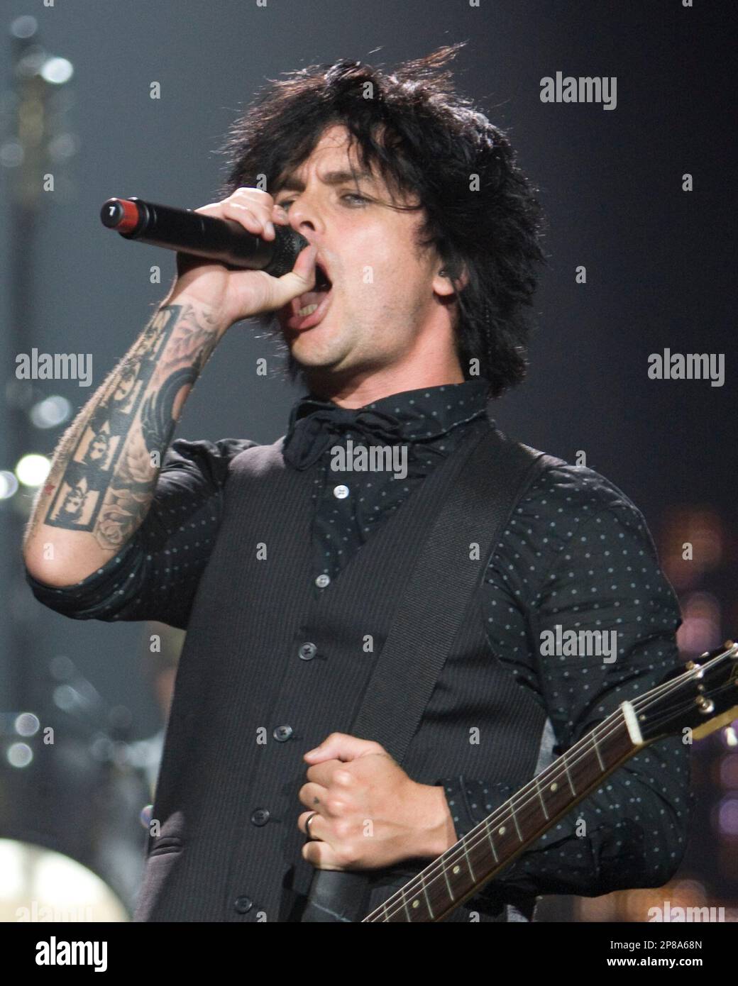 Green Day lead singer Billie Joe Armstrong is silhouetted as he ...