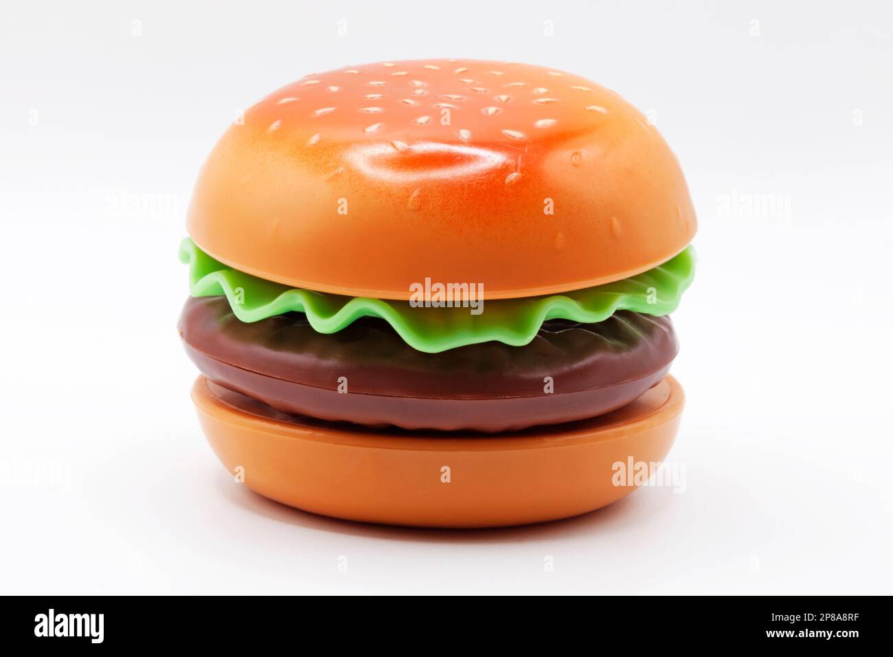 a plastic toy hamburger on a white background Stock Photo - Alamy