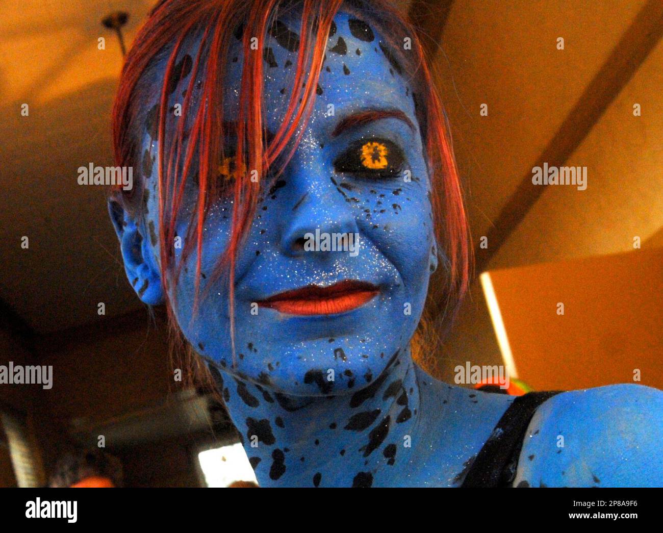 J.B. Letuli, wearing a body paint design by DC Entertainment, awaits to ...