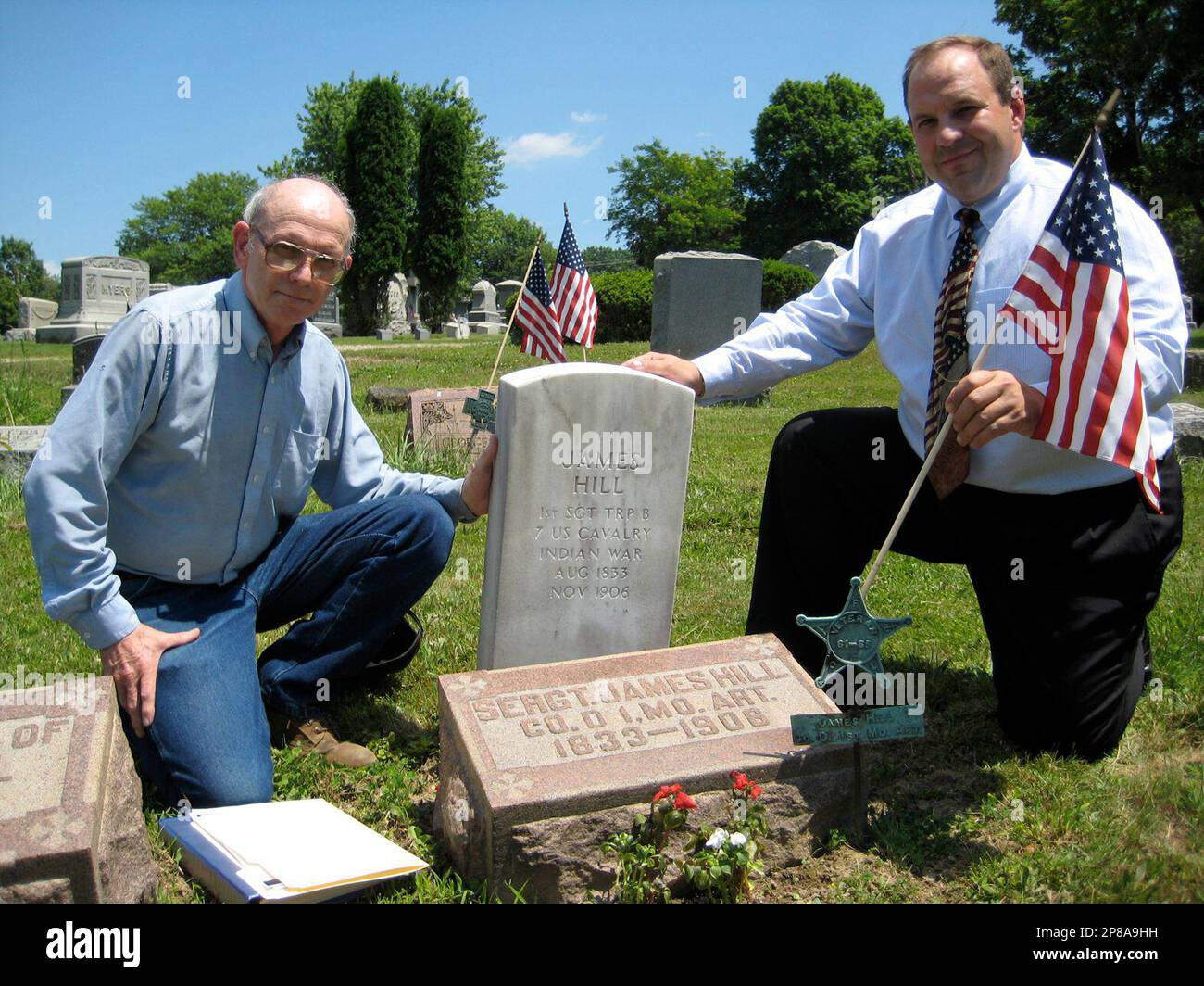 Roger Rower, left, and Jeff Musselman stand by the grave of James Hill ...