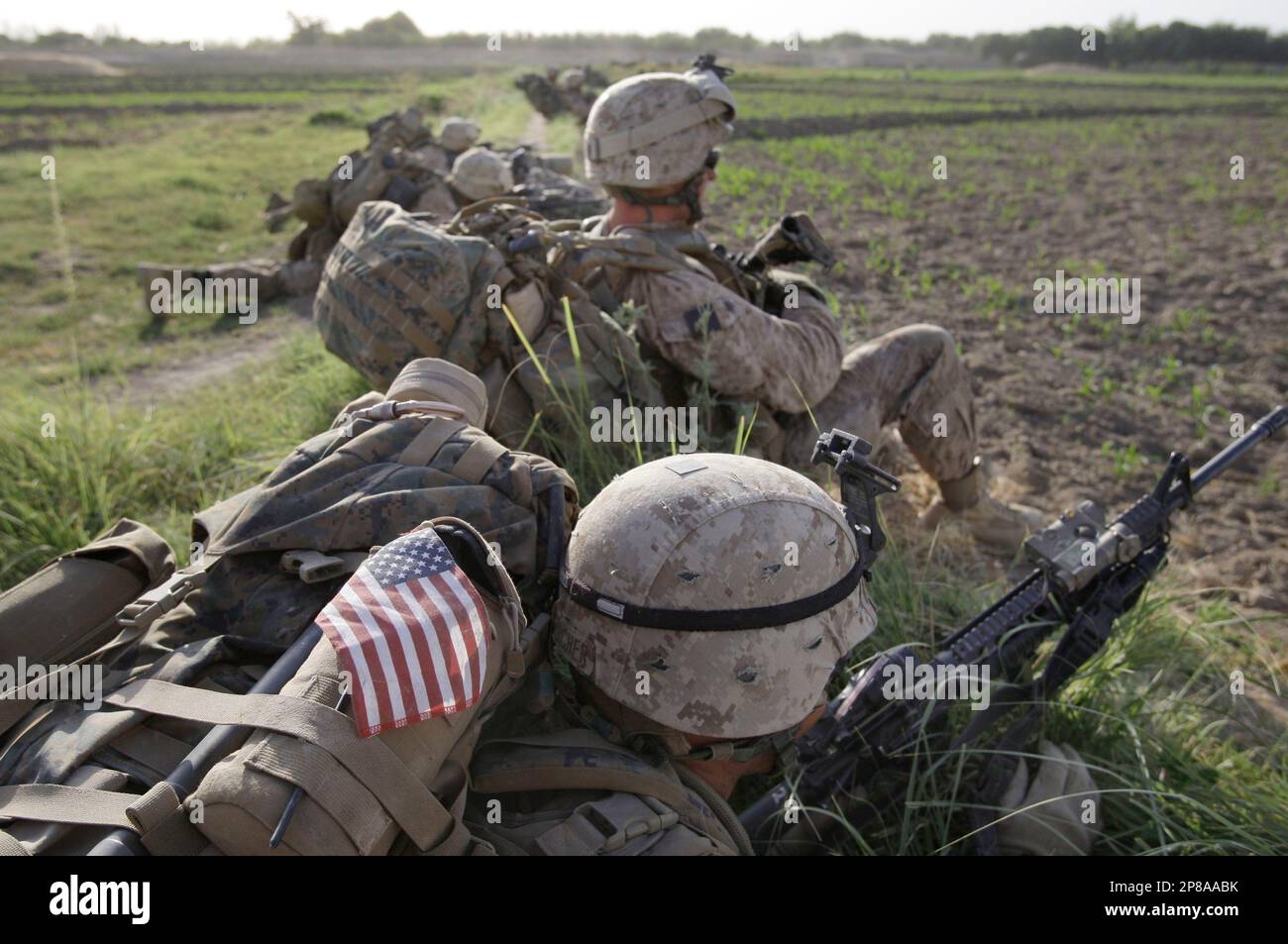 U.S. Marines Cpl. Nolan Archer Dyer, IN, with a U.S. flag in his ...