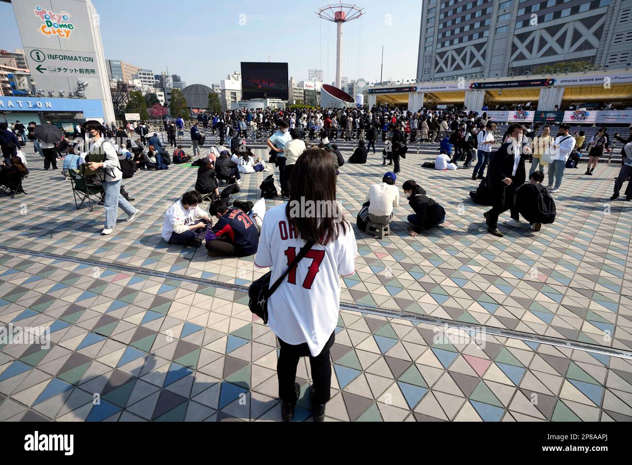 A fan of Japan's Shohei Ohtani stands among other baseball fans prior ...