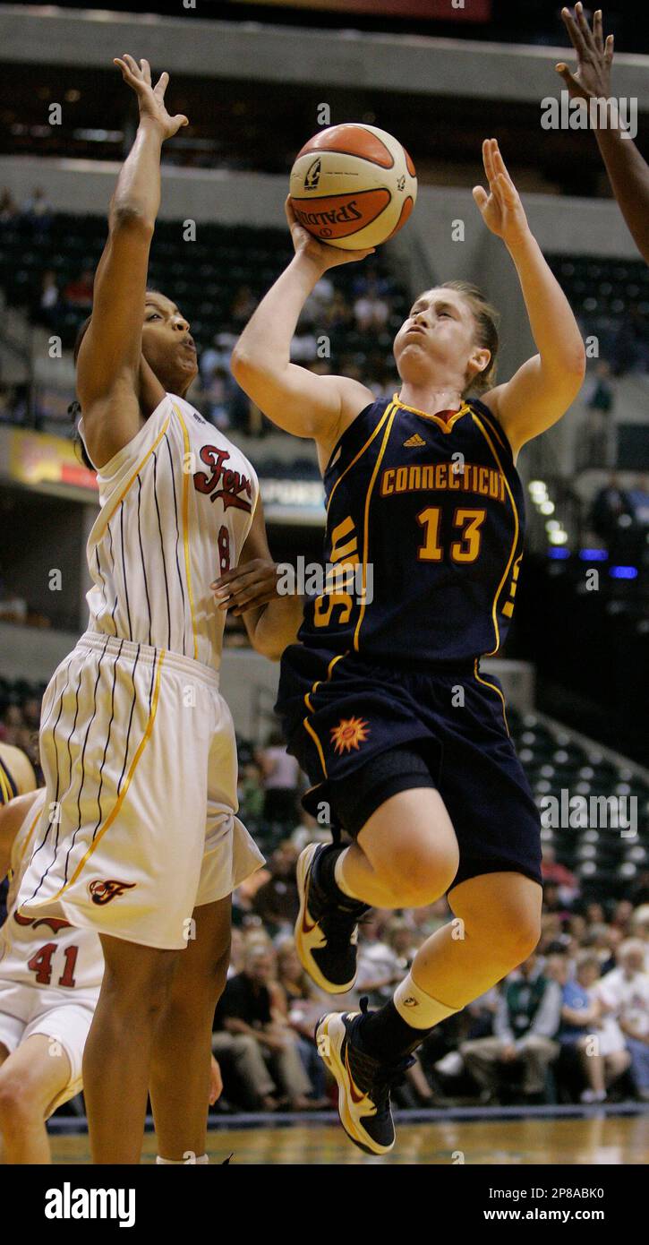 Connecticut Sun's Lindsay Whalen, right, puts up a shot against Indiana Fever's Tammy Sutton ...