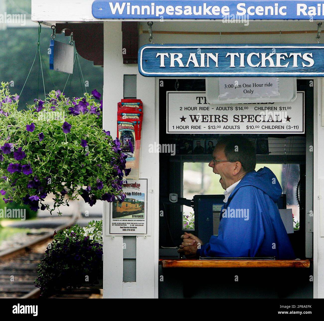 Jim Cluett yawns as he waits for customers at the Lake Winnipesaukee ...