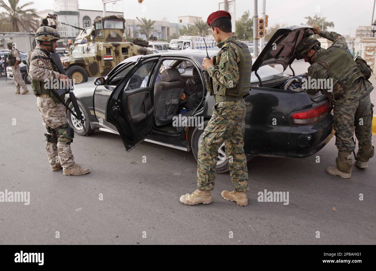 Iraqi soldiers check a car at an army checkpoint in Basra, Iraq's ...