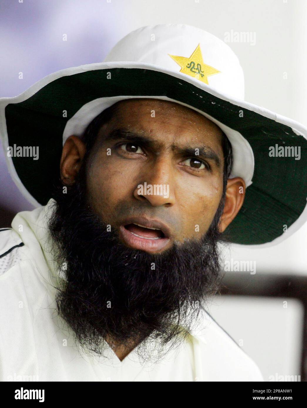 Pakistani cricketer Mohammad Yousuf looks on as he sits out side their ...
