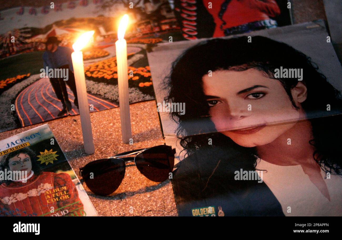 Photographs of late US singer Michael Jackson sit next to candles ...