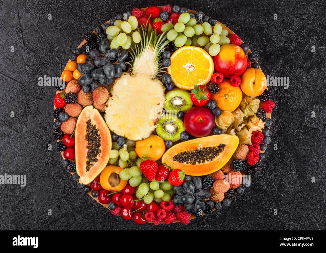 Fresh raw organic summer berries and exotic fruits in round large tray ...