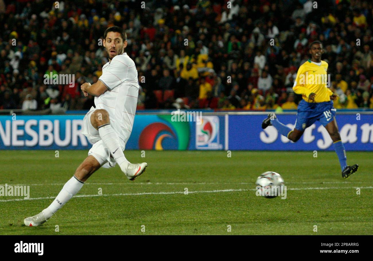 USA's Clint Dempsey, left, goes to score the opening goal, as Brazil's ...