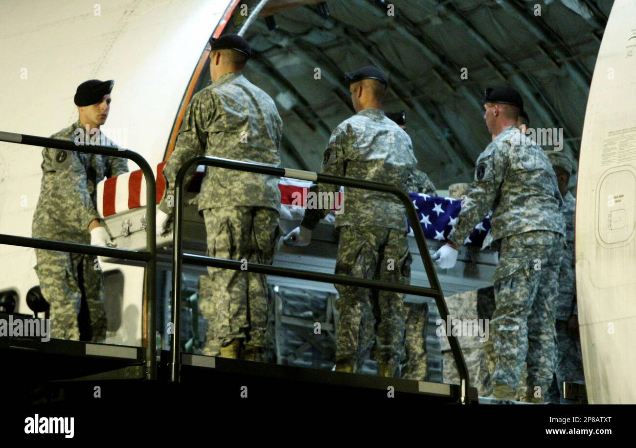 An Army Corps carry team carries the transfer case containing the ...