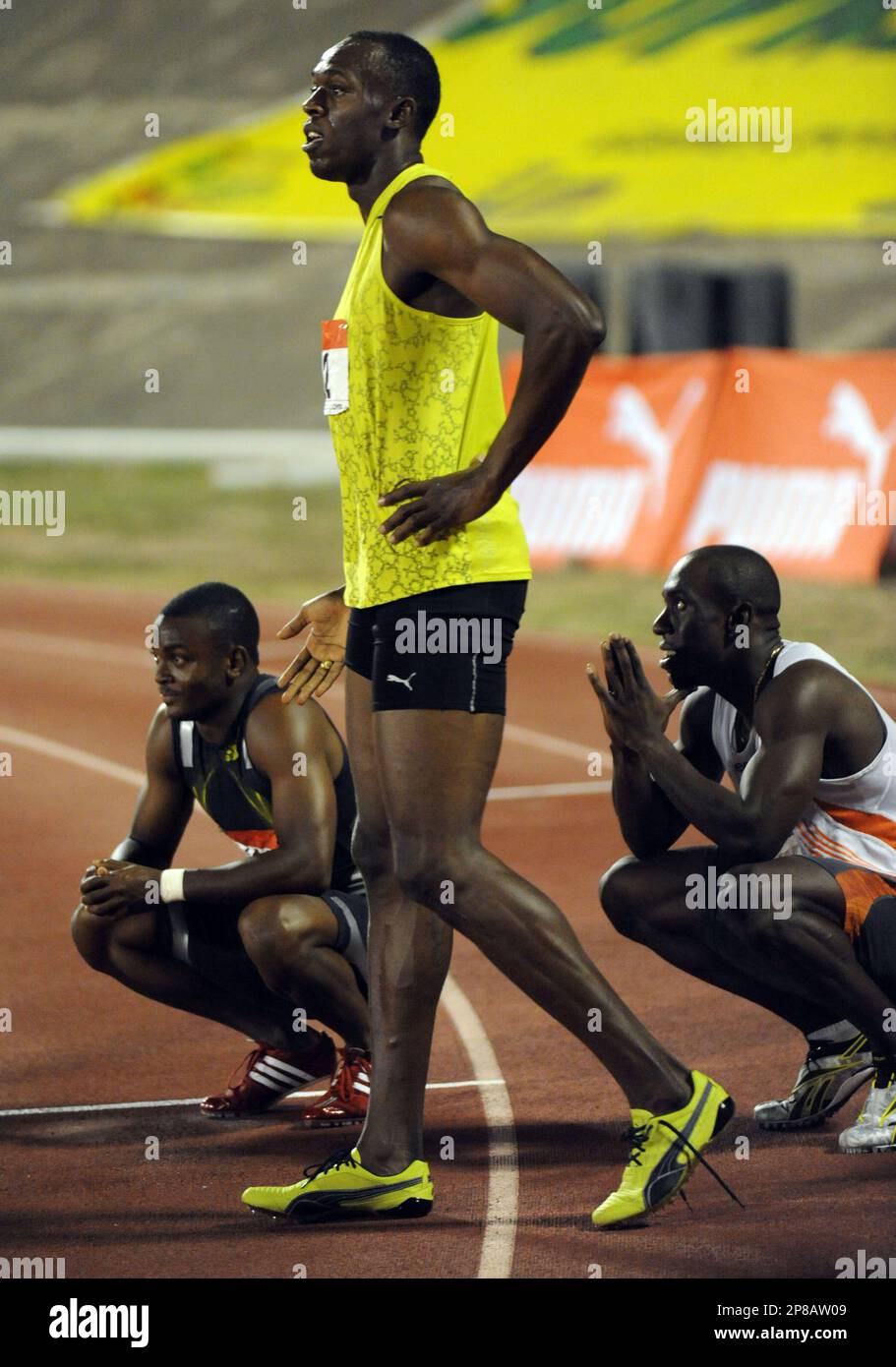 Olympic sprint double champion Usain Bolt of Jamaica, center, waits for ...