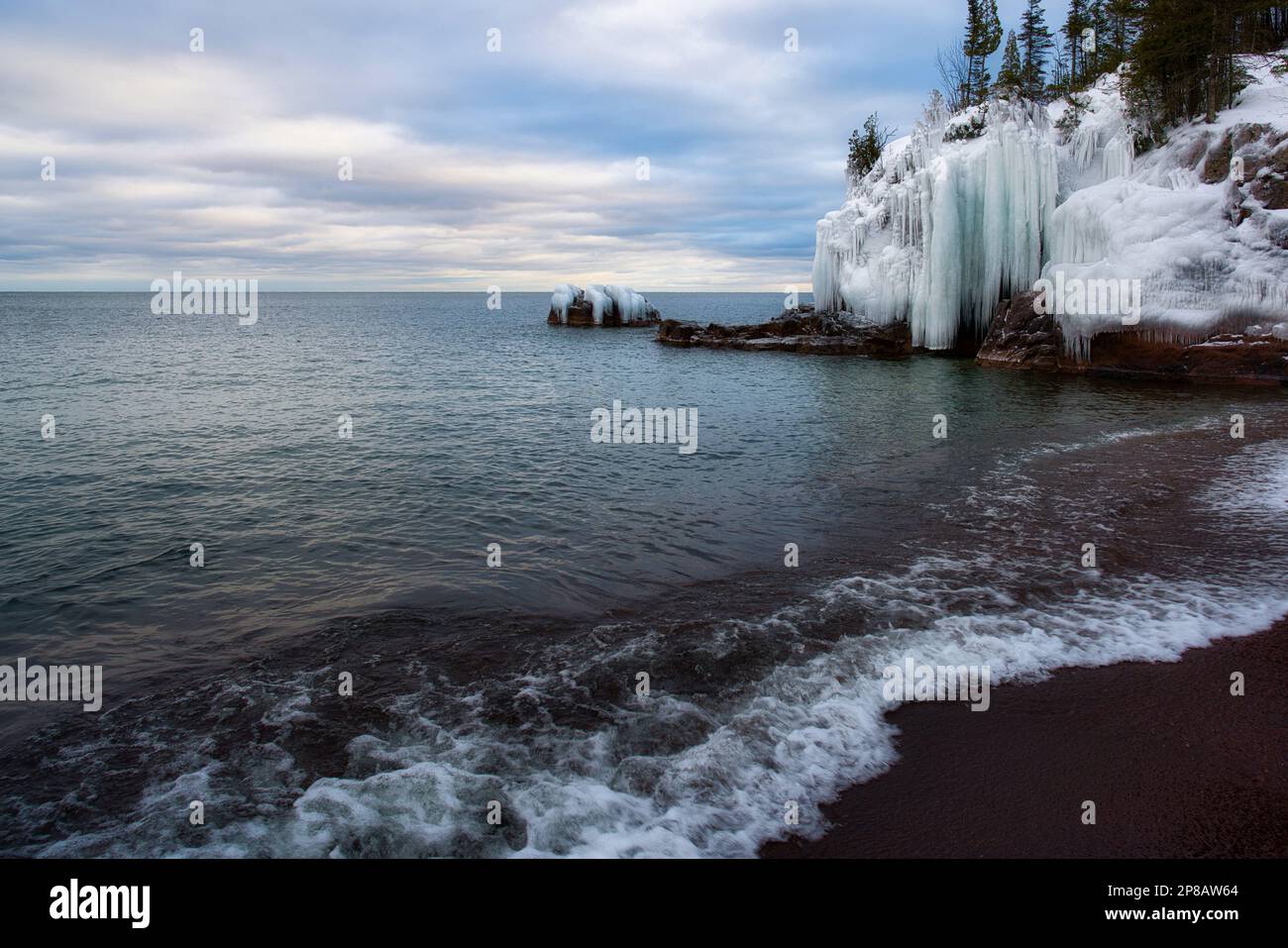 A beautiful winter scene featuring a stunning frozen lake, with ice ...