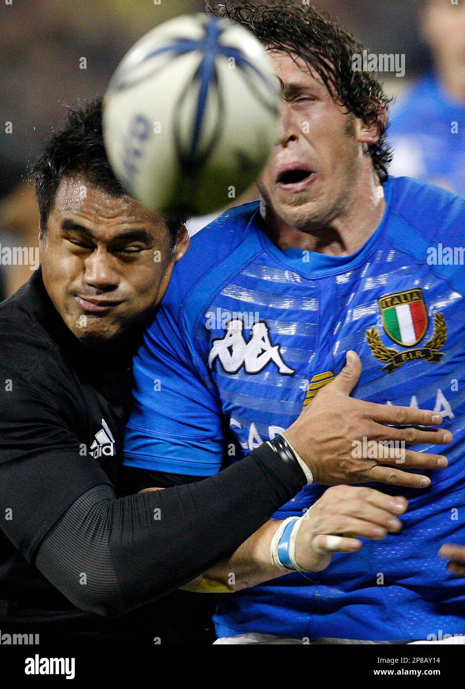 Italy's Mirco Bergamasco is hit hard in the tackle of New Zealand's ...