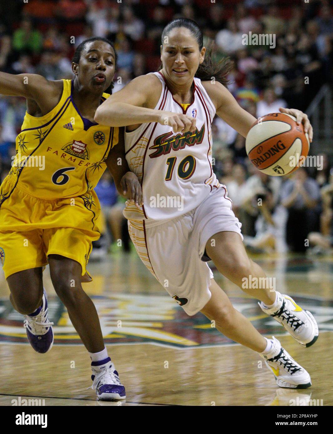 Seattle Storm's Sue Bird drives past Los Angeles Sparks' Shannon ...