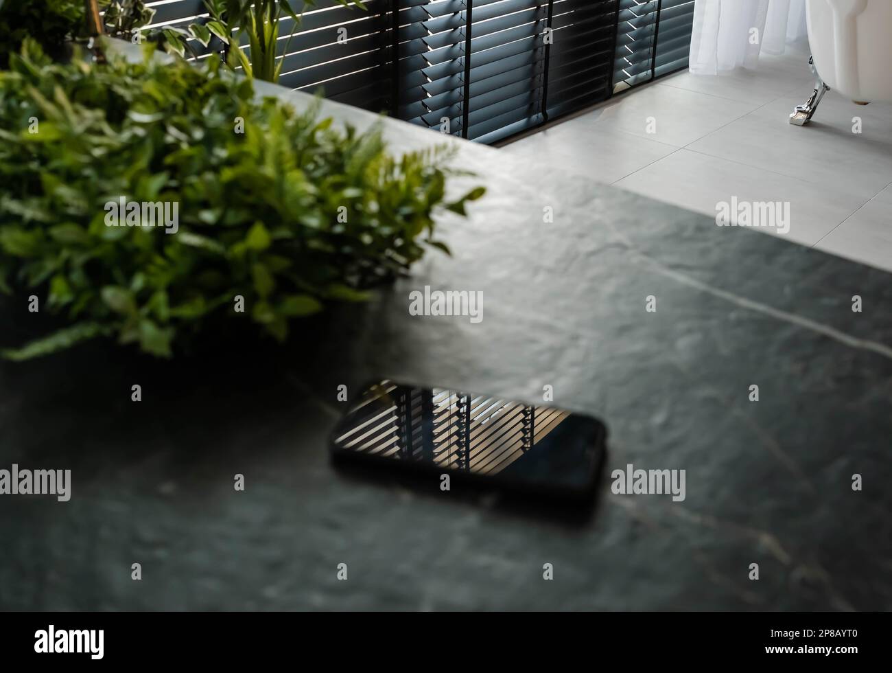 Electronic devices. A single mobile phone on wooden table in the home ...