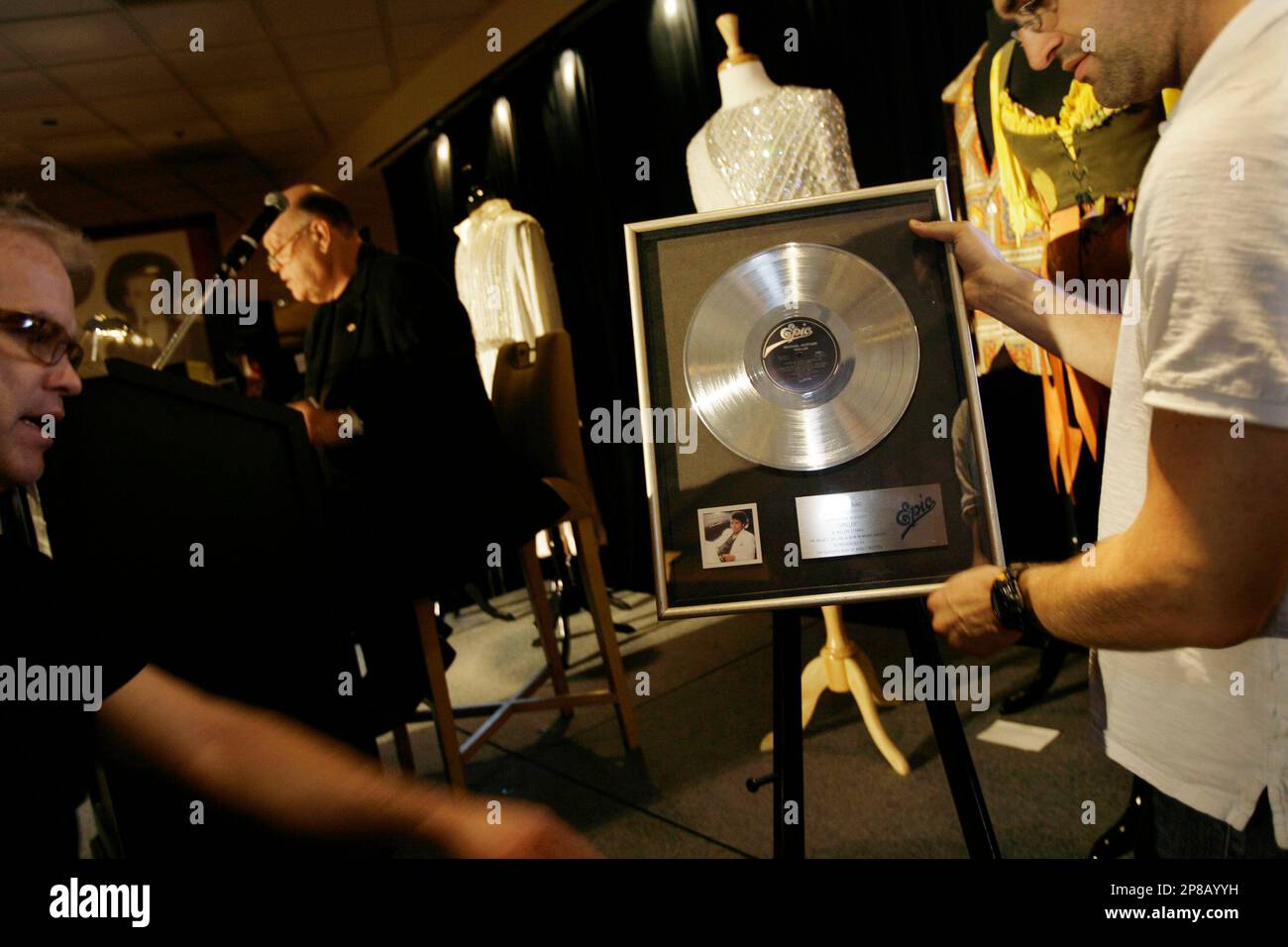 Rush Jenkins, left, and Klaus Baer prepare a display with a platinum ...