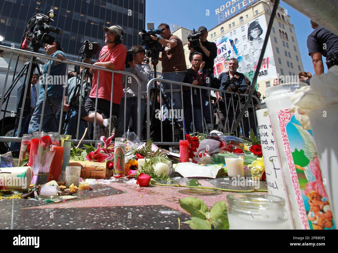 Photographers shoot a sidewalk shrine on the star of Michael Jackson on ...