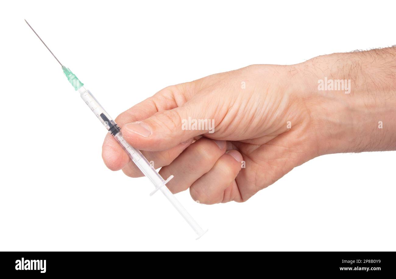New syringe in adult hand on white background, medical and health care ...