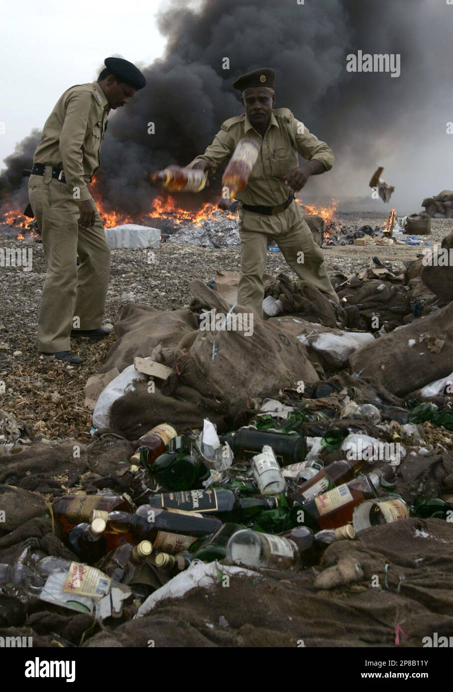 Officers of the Pakistani Narcotic Control Force pile up bottles of ...