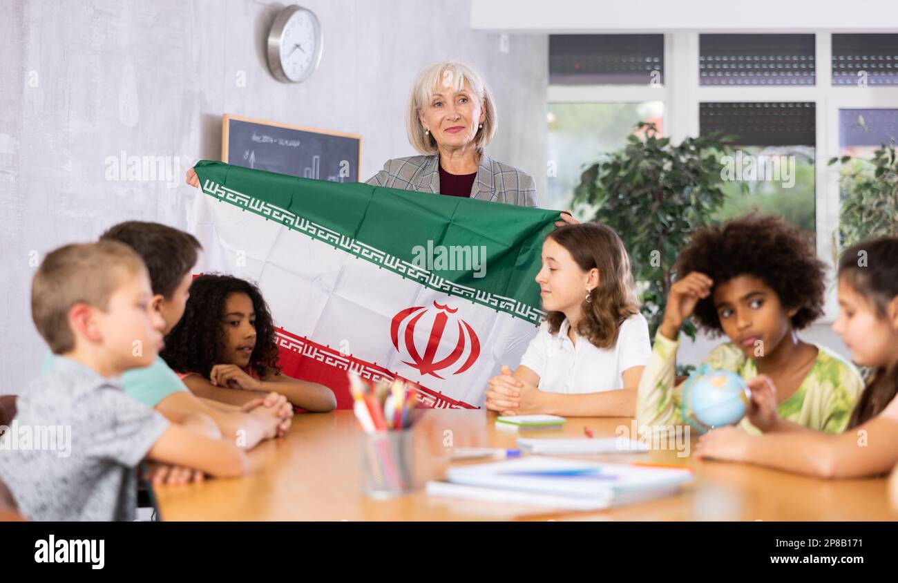 students listen to woman teacher who talks about Iran Stock Photo - Alamy