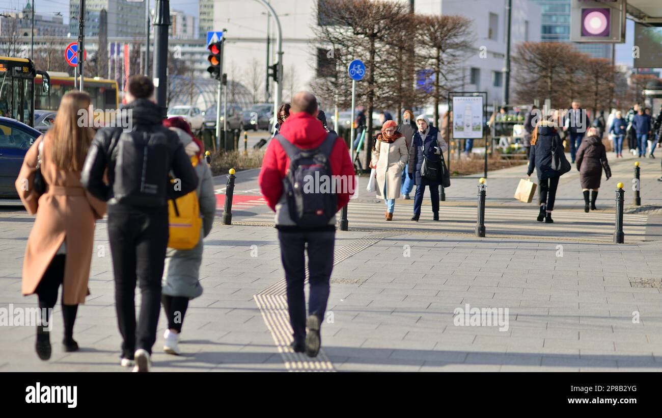 Warsaw, Poland. 8 March 2023. Crowd of people walking down an urban ...