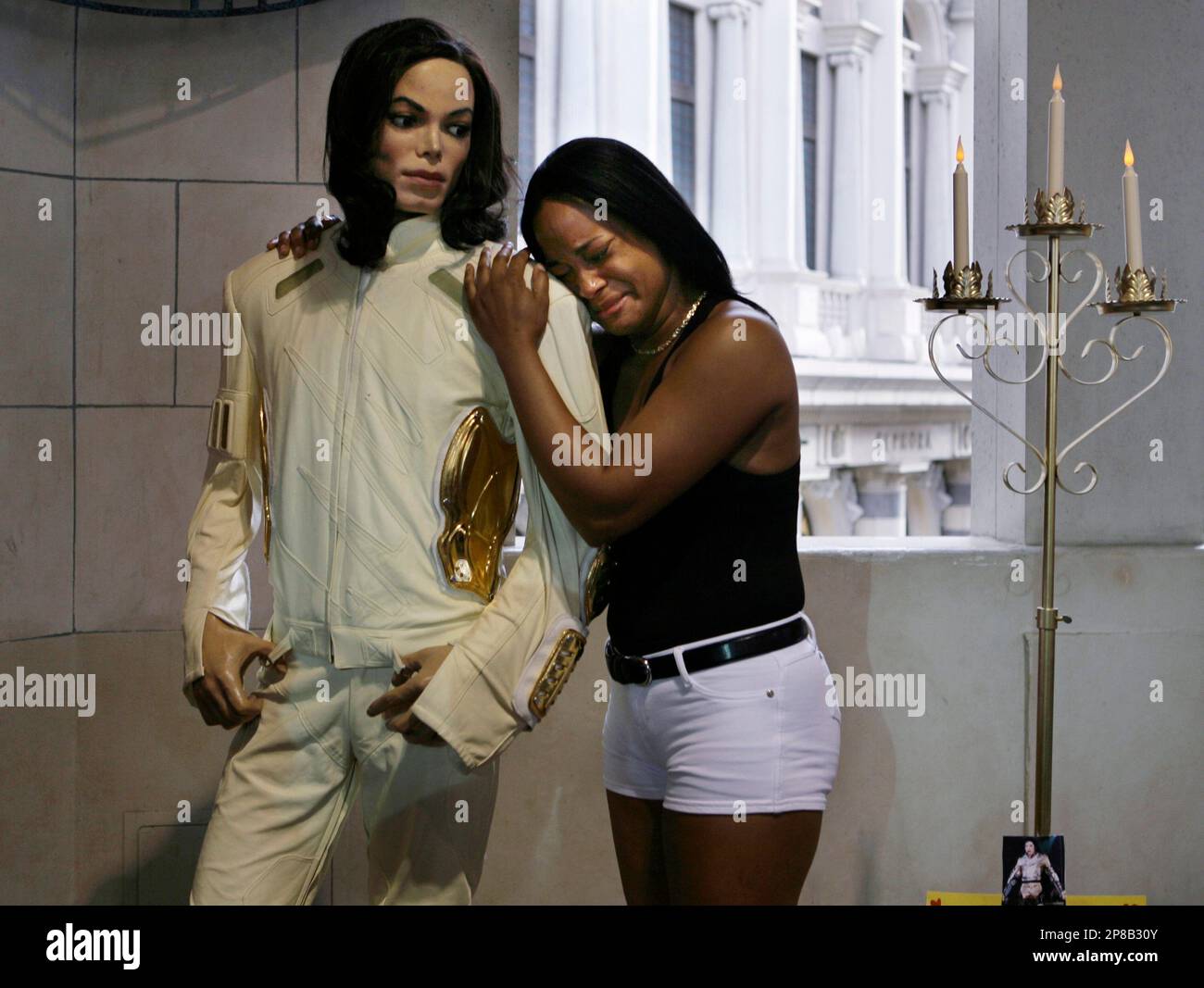 Shayla Ivy cries as she holds a wax replica of Michael Jackson outside ...