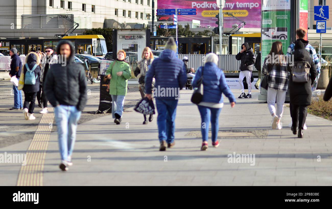 Warsaw, Poland. 8 March 2023. Crowd of people walking down an urban ...