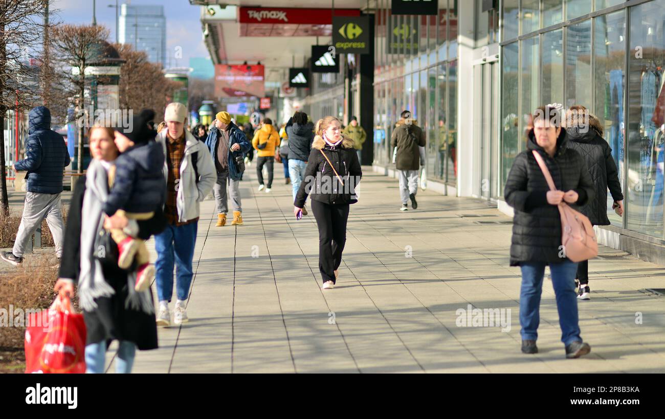 Warsaw, Poland. 8 March 2023. Crowd of people walking down an urban ...
