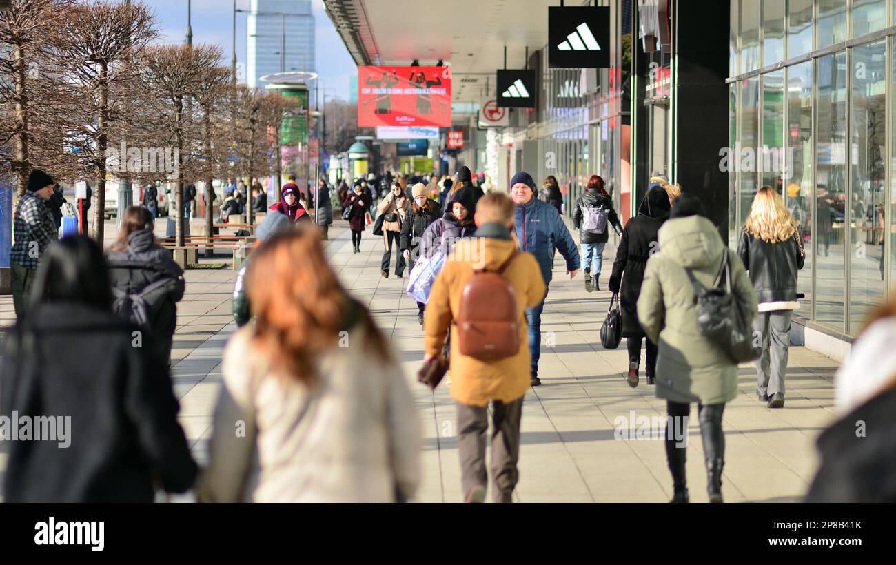 Warsaw, Poland. 8 March 2023. Crowd of people walking down an urban ...