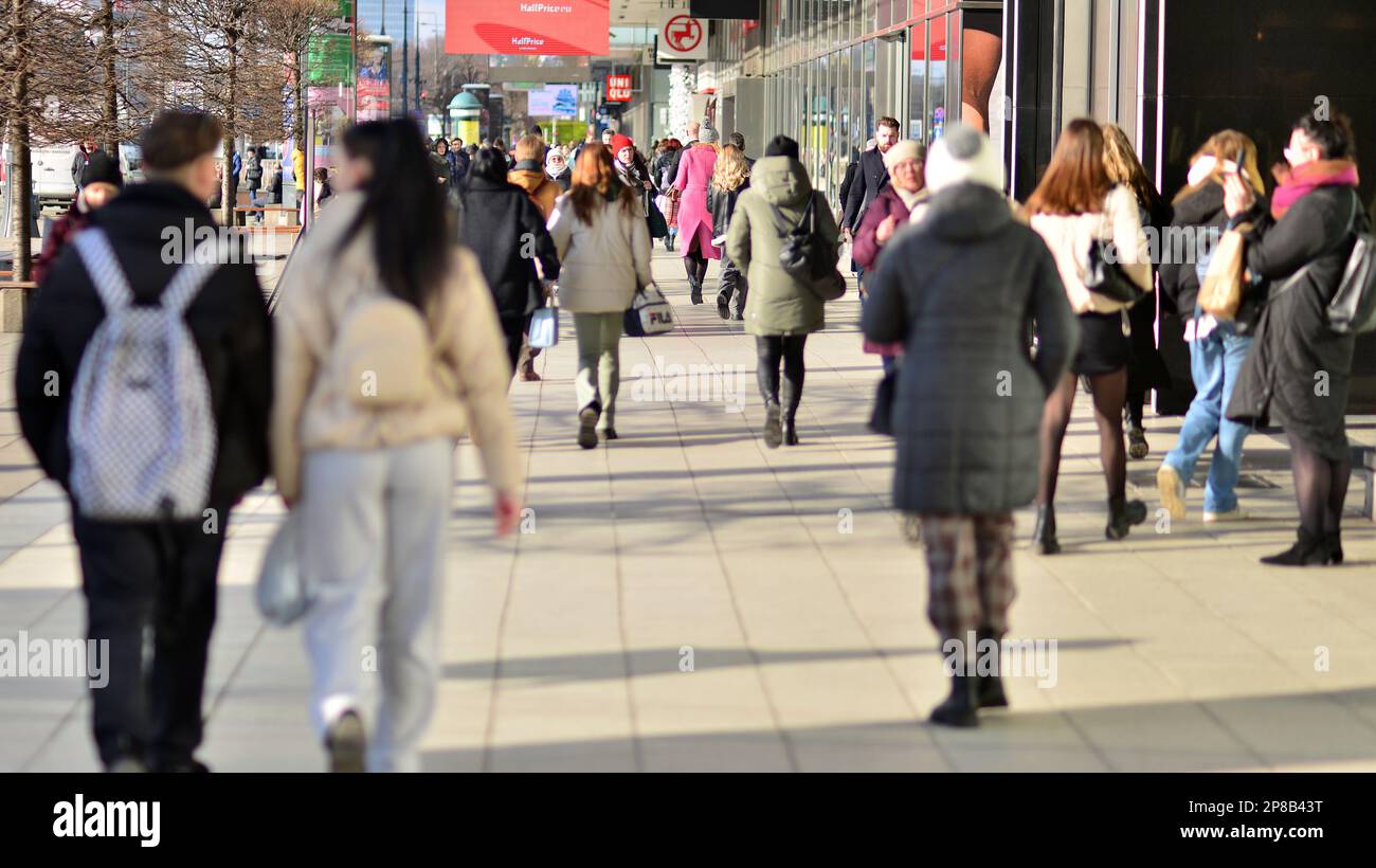 Warsaw, Poland. 8 March 2023. Crowd of people walking down an urban ...
