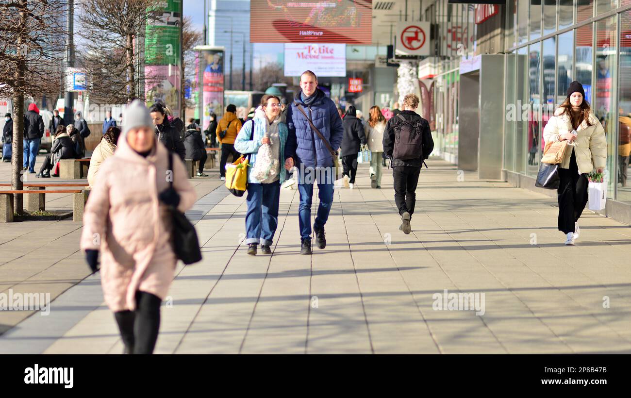 Warsaw, Poland. 8 March 2023. Crowd of people walking down an urban ...