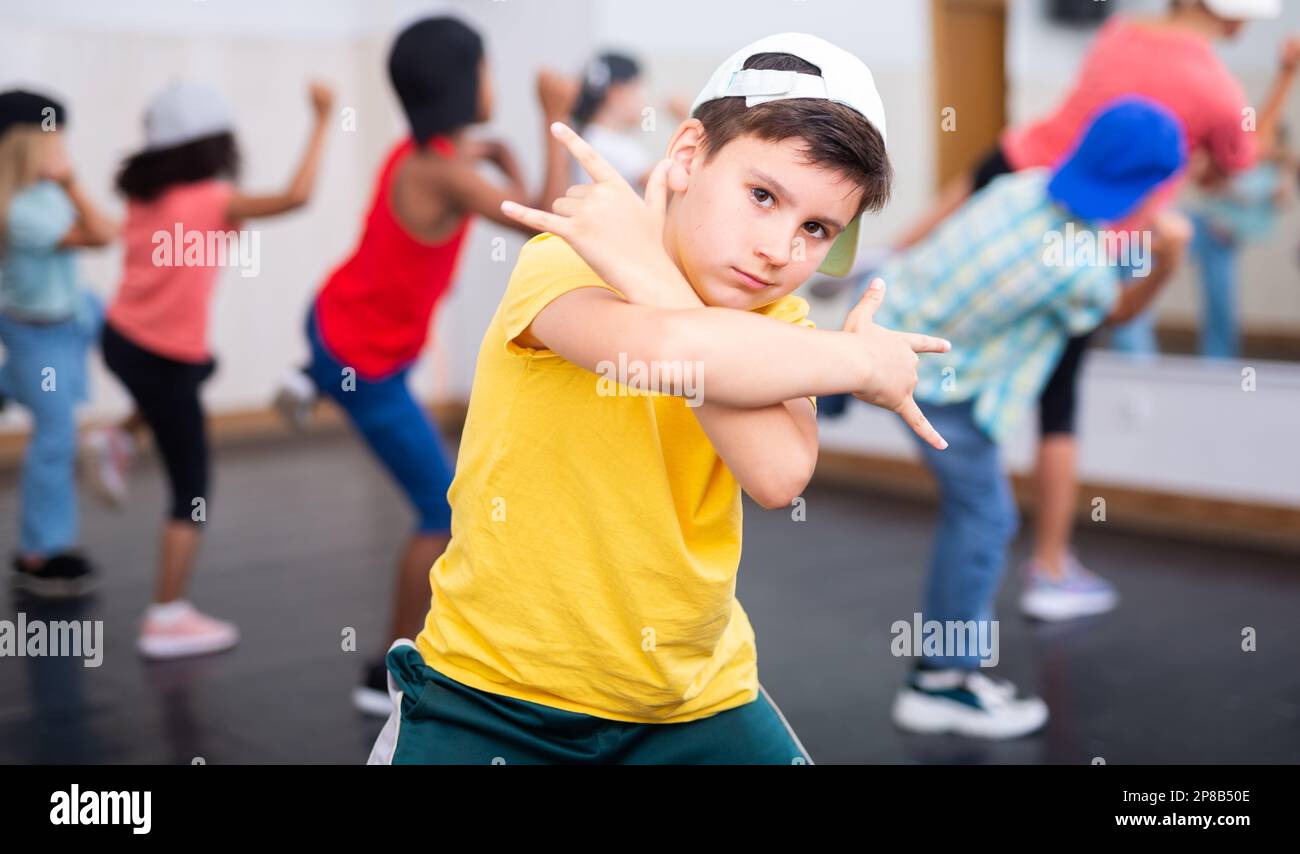 Preteen girl practicing dance movements with group of children Stock ...