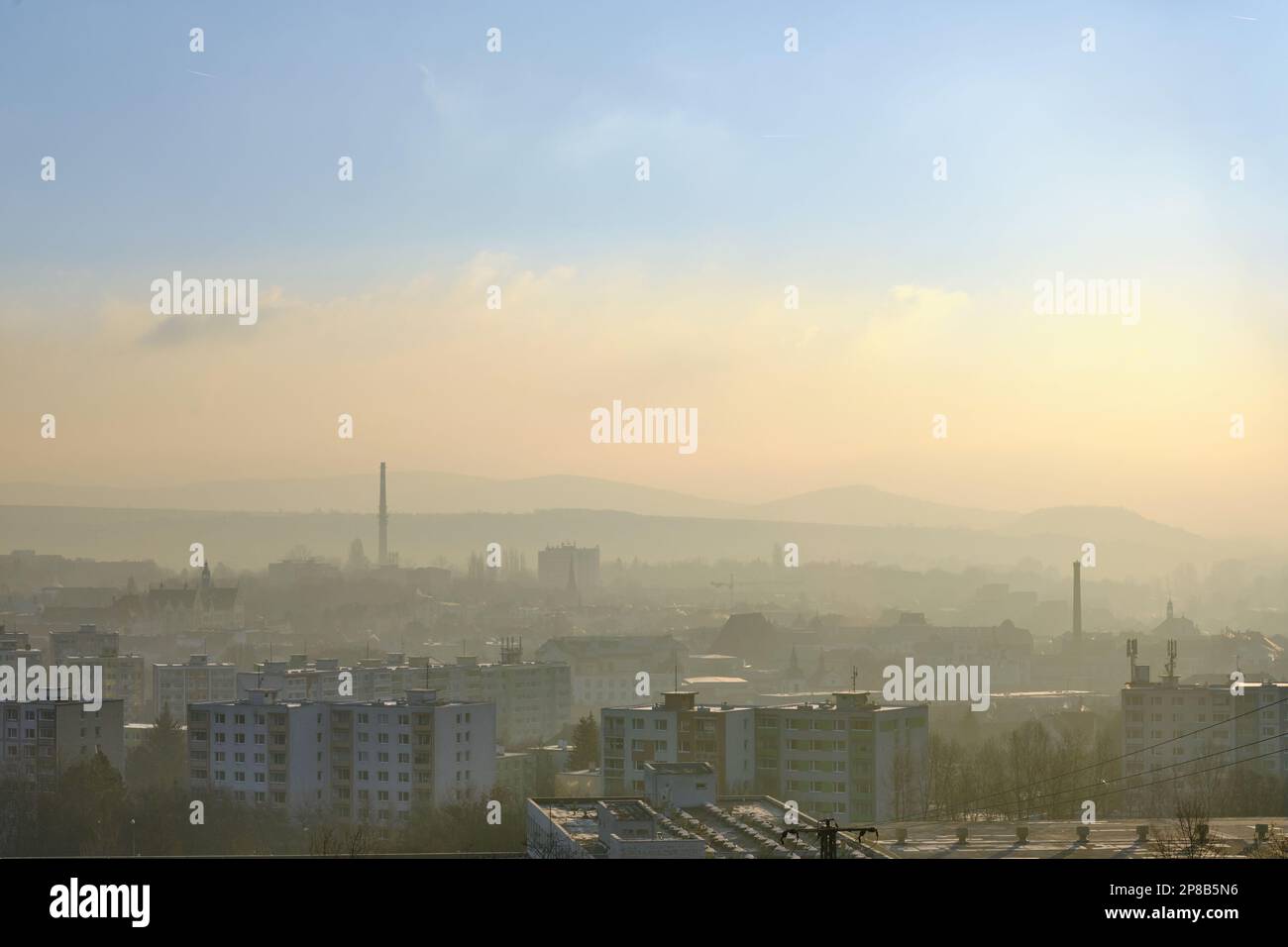 Smog air pollution over a small historic industrial town with mountains and hills in the ...