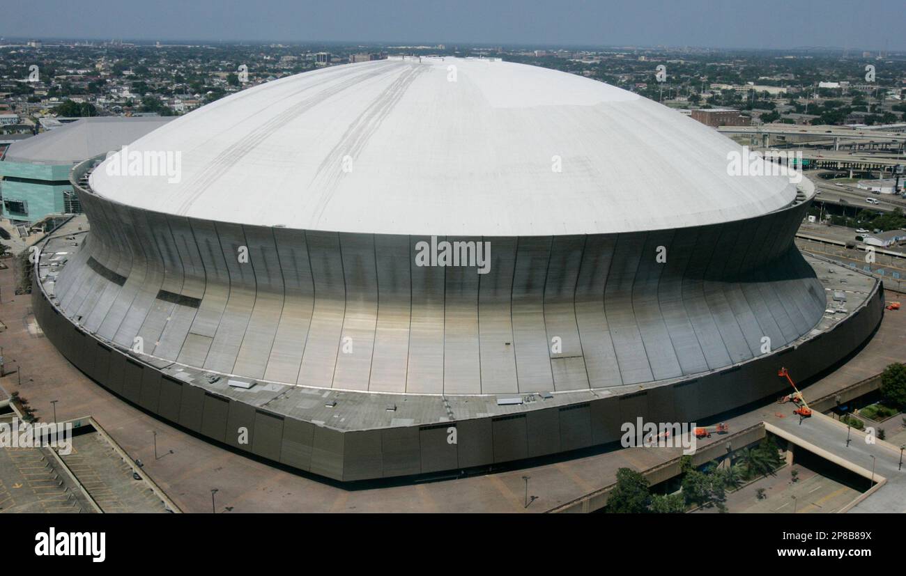 Workers clean the roof of the Louisiana Superdome in New Orleans ...