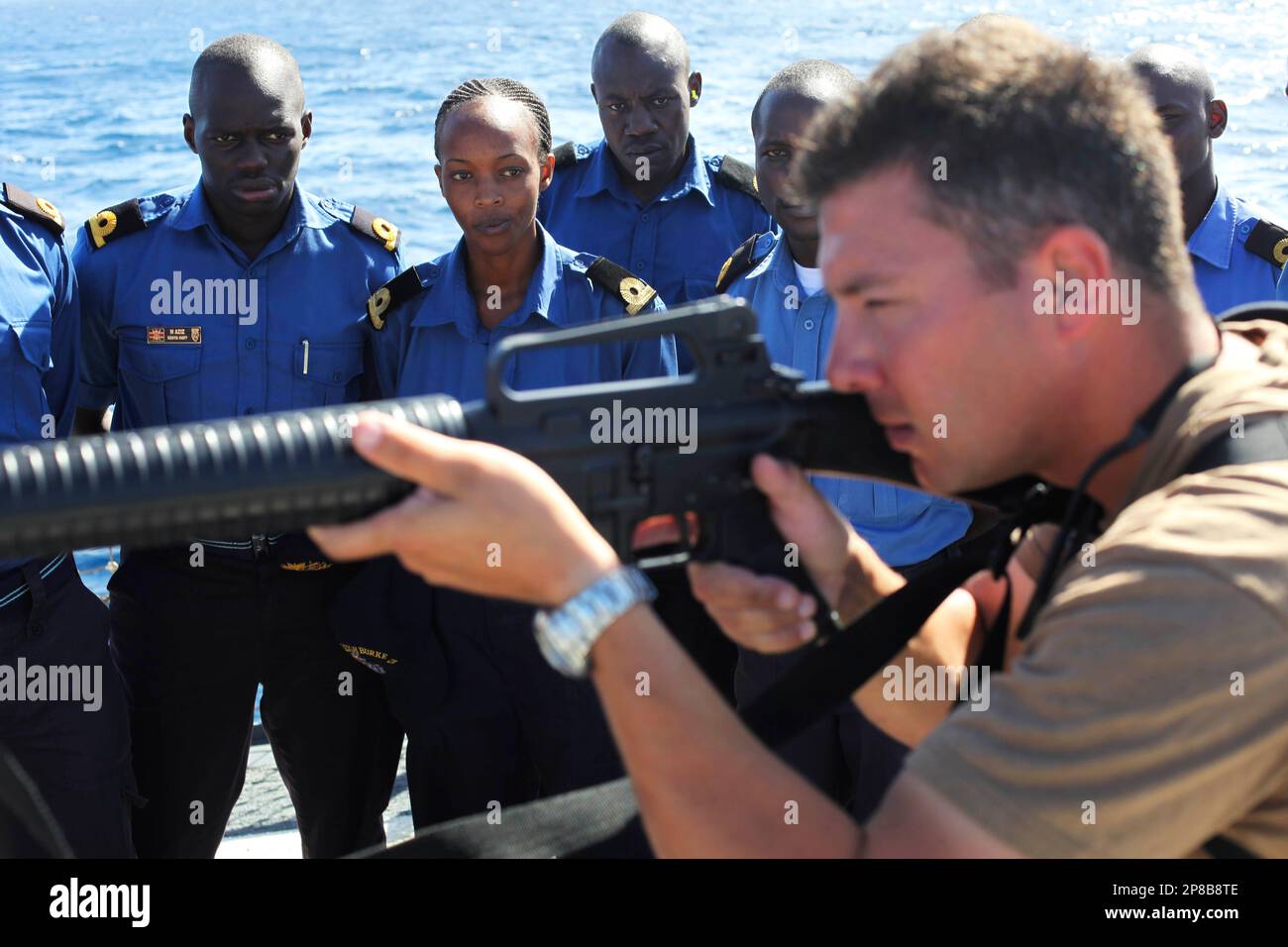 Kenyan navy sailors watch as Gunners Mate First Class Benjamin O'Connor ...