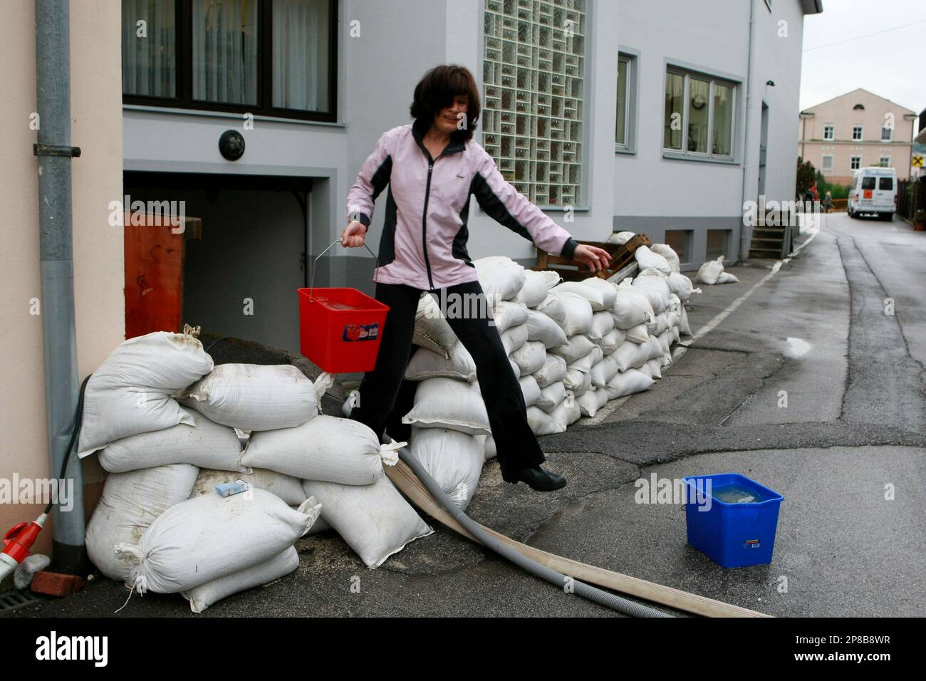A habitant of Kremsmuenster in Upper Austria carries water out of her ...